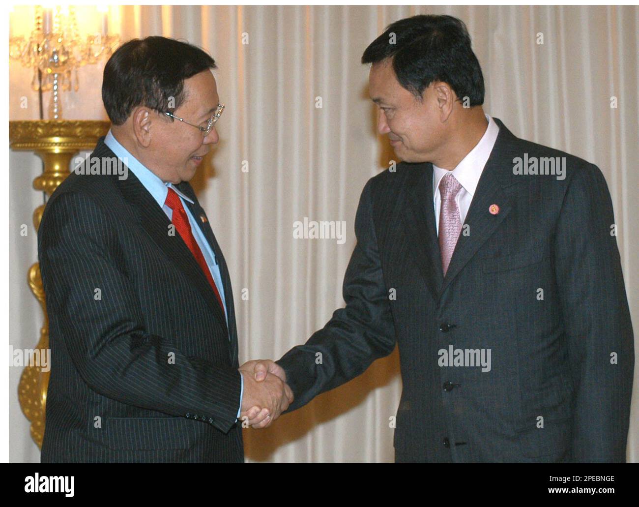 Thailand's Prime Minister Thaksin Shinawatra, right, greets Philippine ...