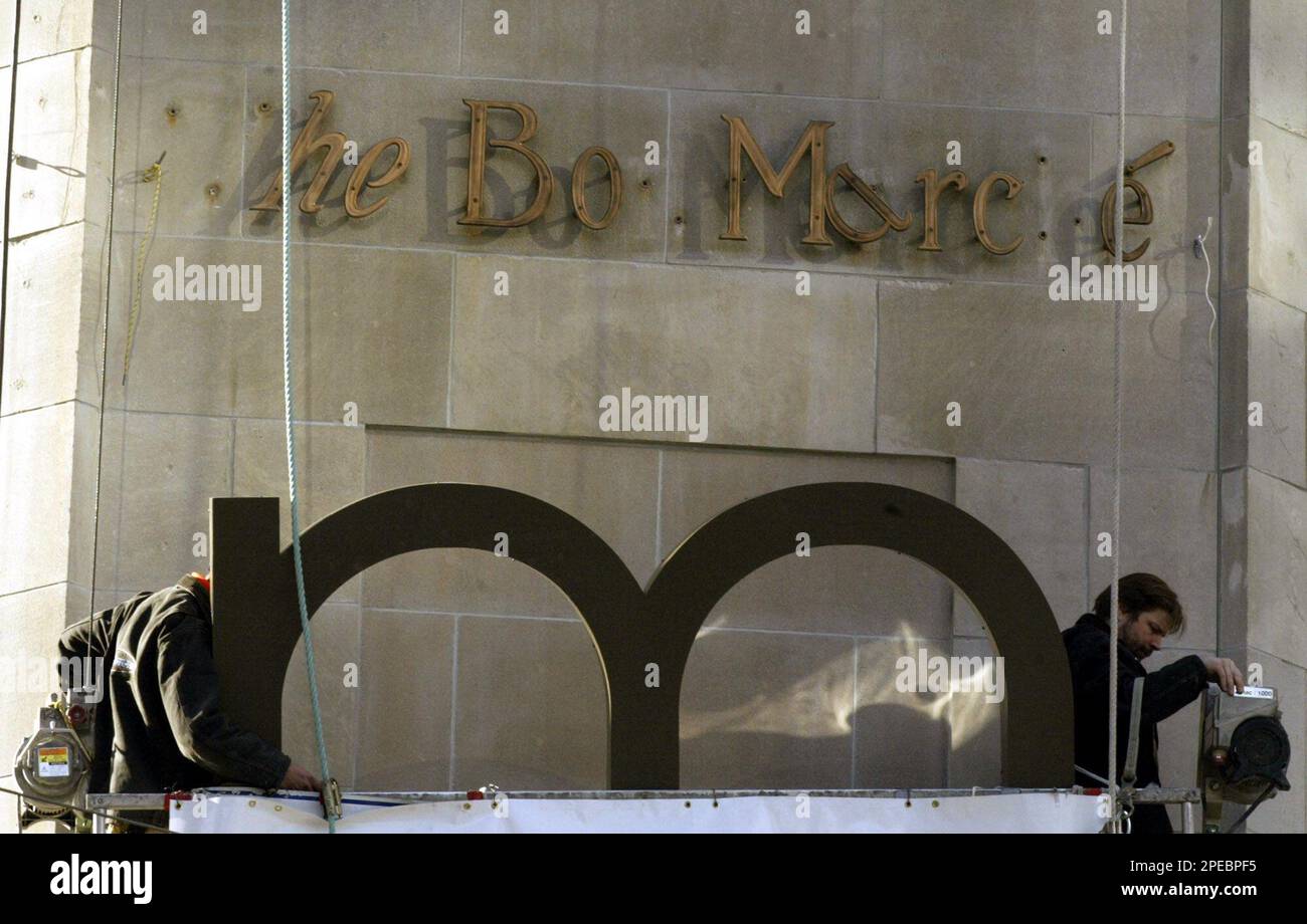 **FILE** Workers use a hoist to carry a the giant 'm' from a new Macy's ...