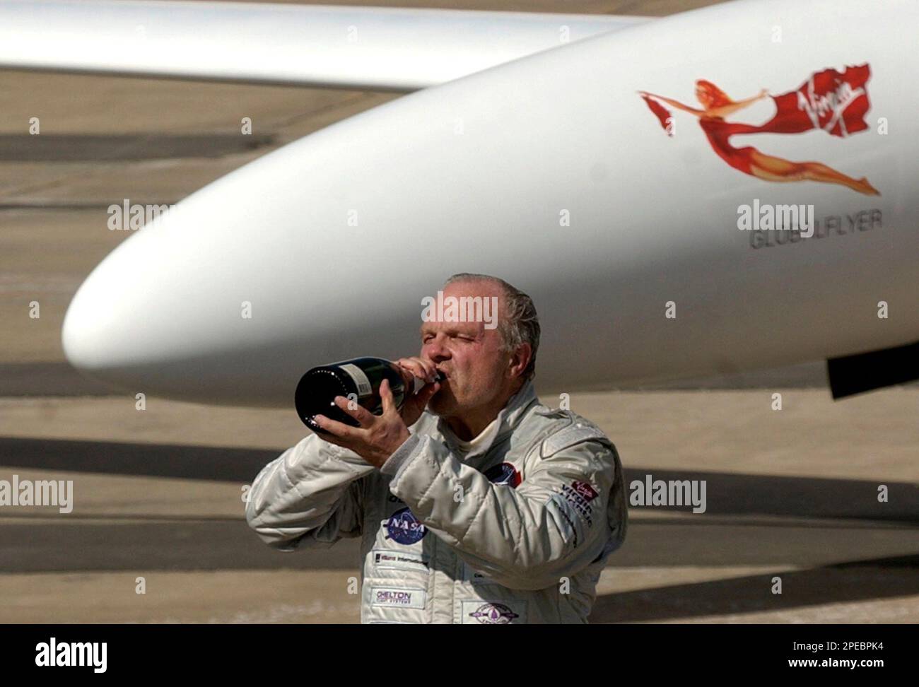 Steve Fossett celebrates with a drink of champagne after landing the ...