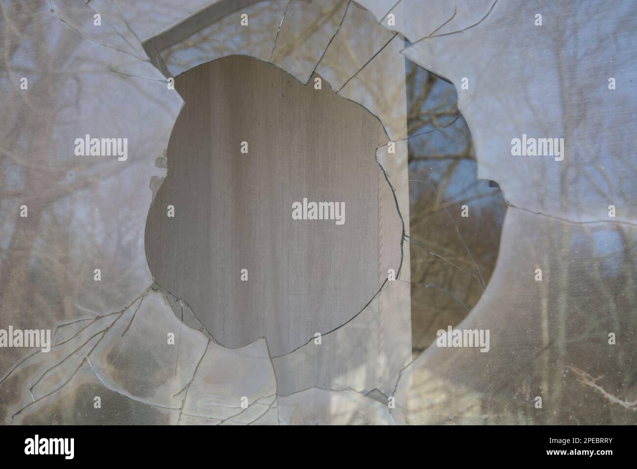 Broken window with curtain behind the fractured glass, and additional ...