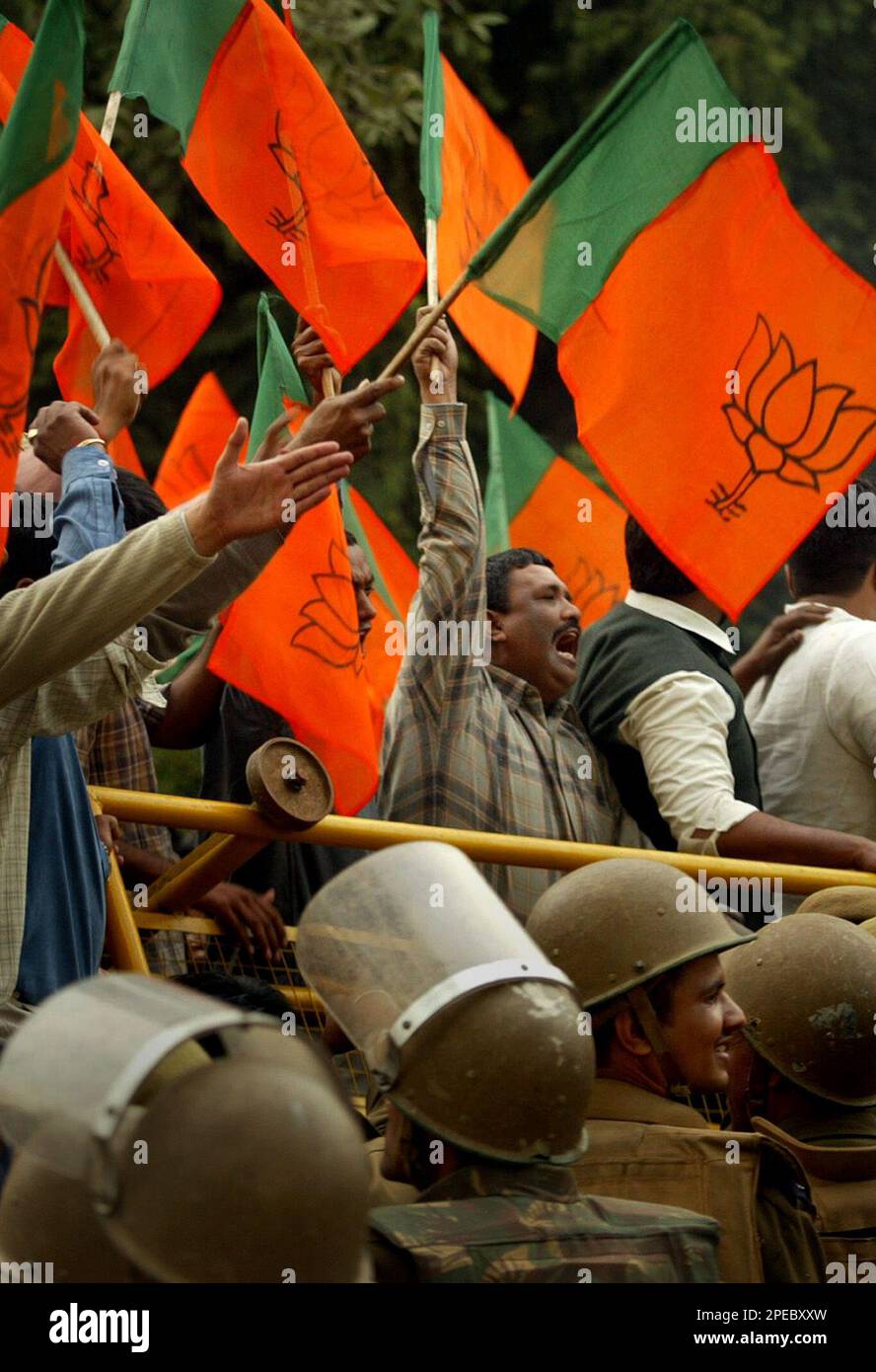Holding their party flags, Bharatiya Janta Party (BJP) activists try to ...
