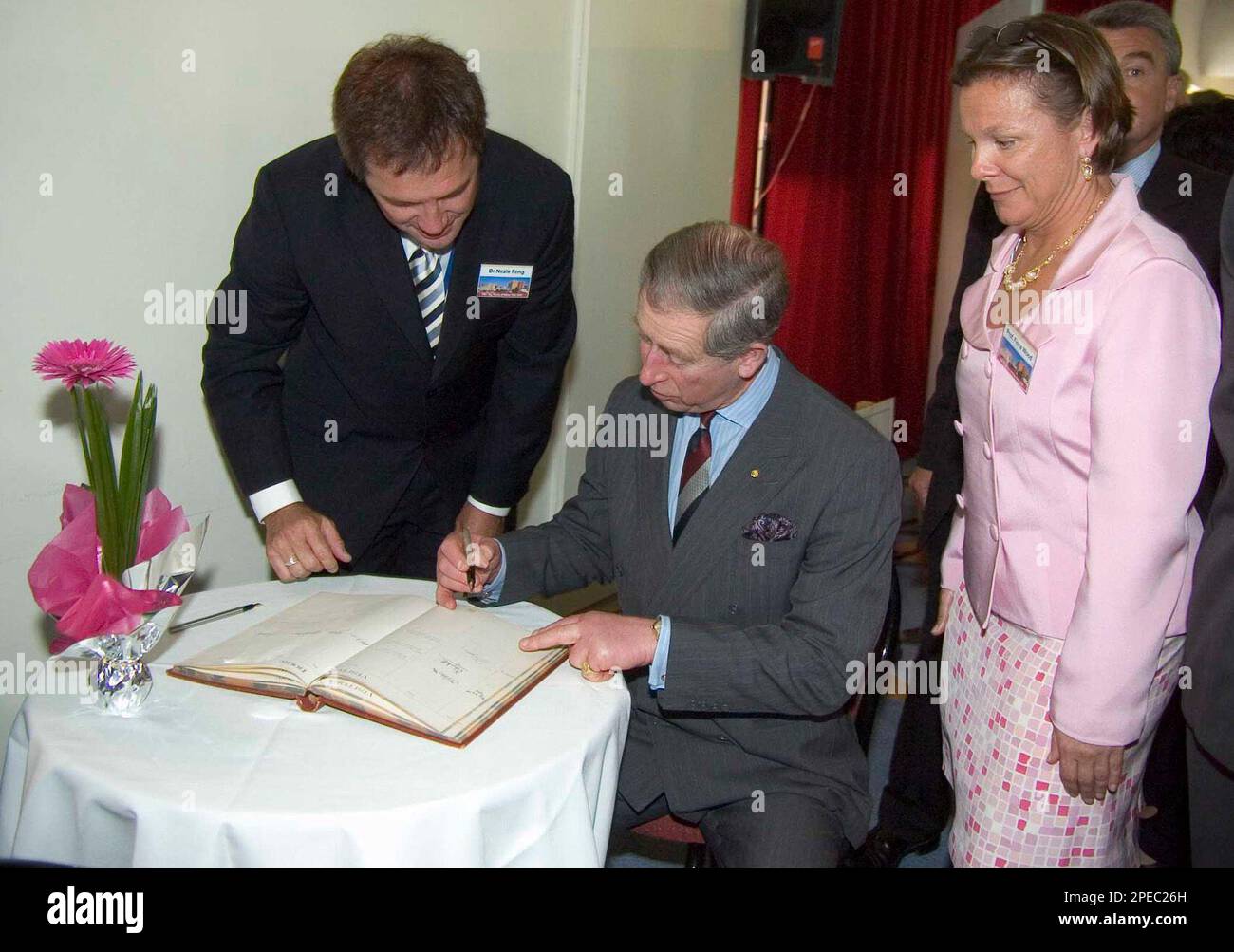 Britain's Prince Charles, center, signs the visitor's book at Royal ...