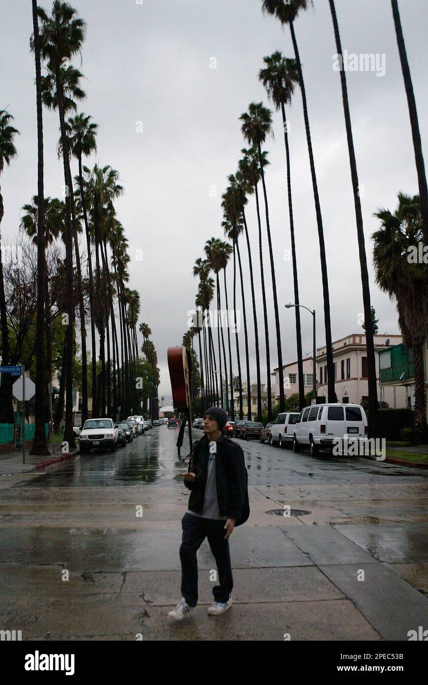 Andrew Stone, a teenage guitarist balances his guitar on the tip of his ...