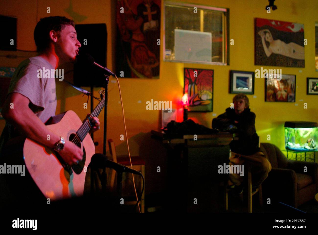 Andrew Stone, a homeless teenage guitarist, left, plays at the ...