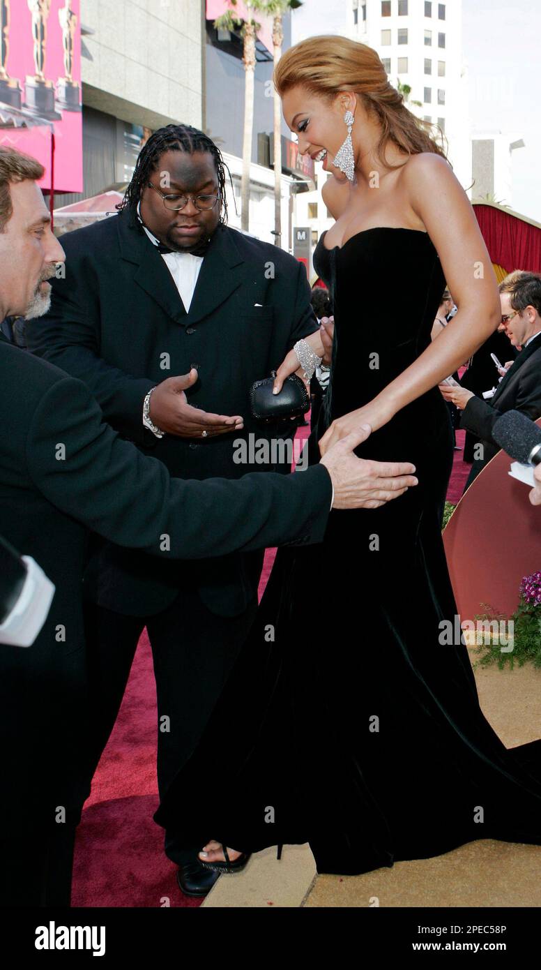 Beyonce Knowles is helped down from an interview podium as she arrives ...