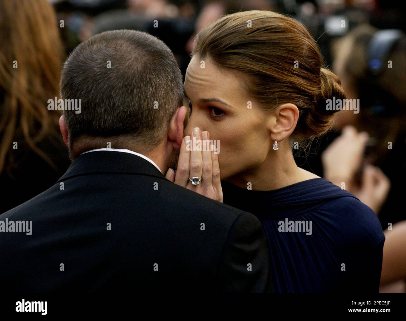 Best actress nominee Hilary Swank whispers in the ear of her publicist ...