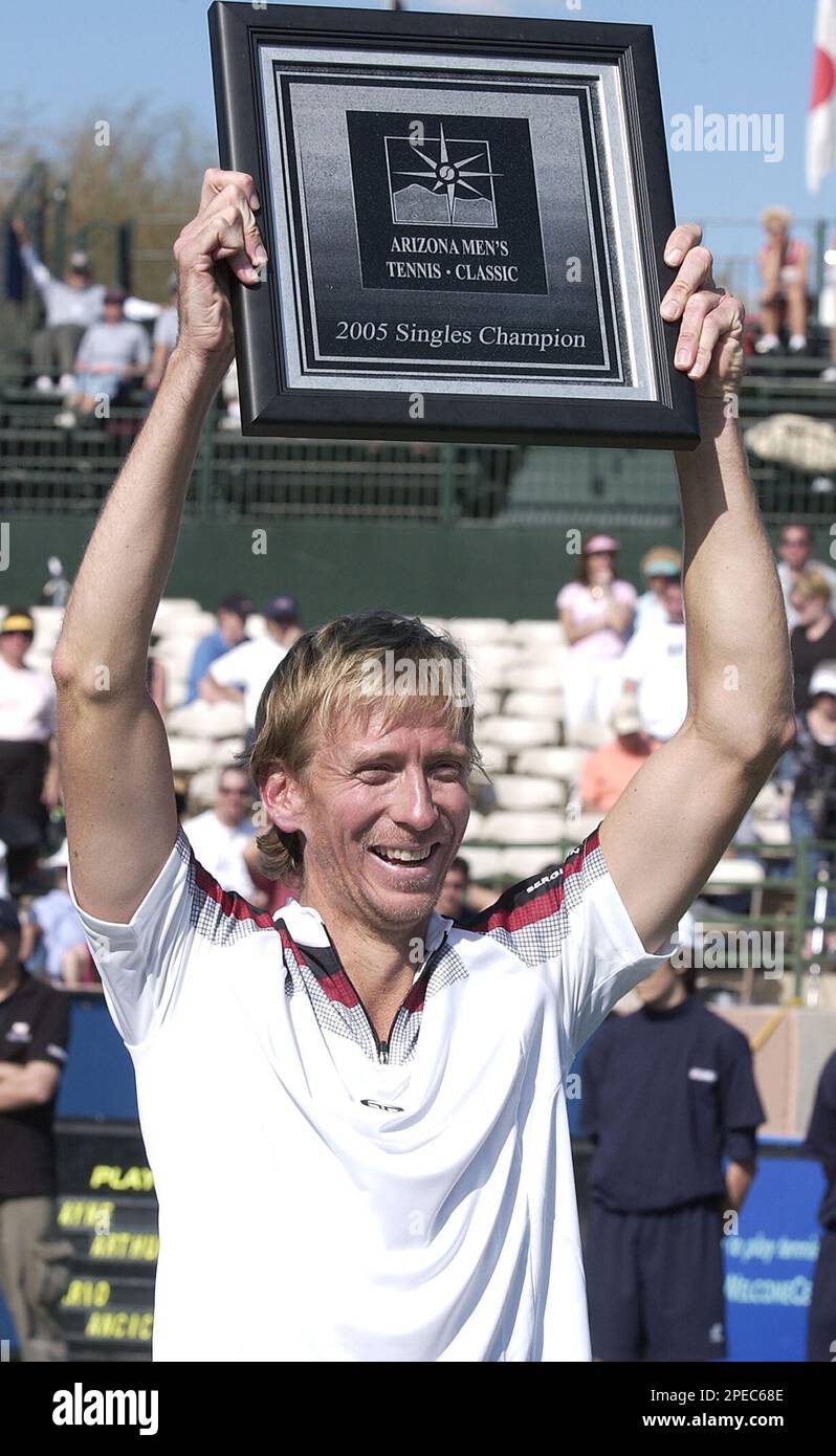 Wayne Arthurs of Australia raises the championship trophy after ...