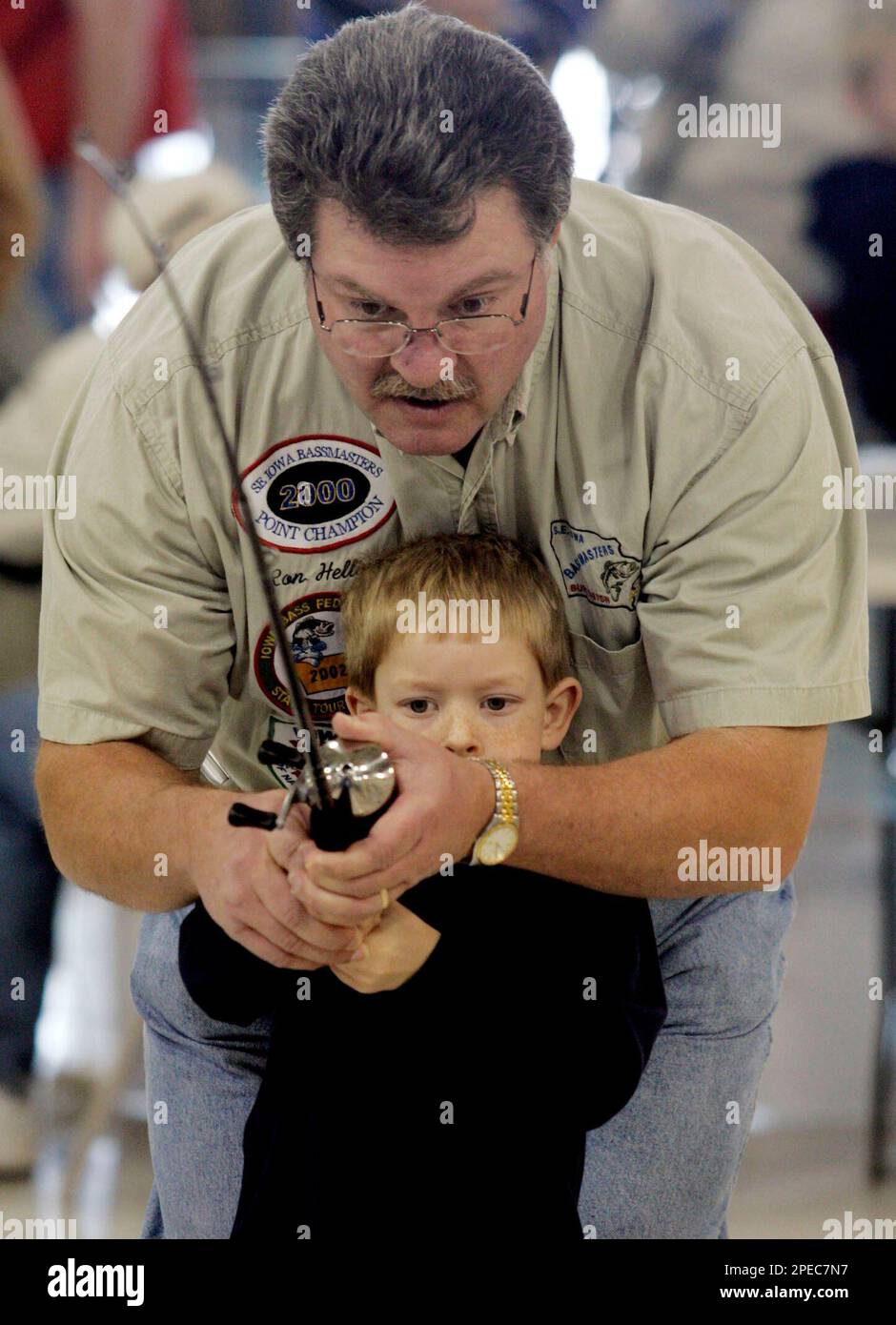 Colin Hirte, 7, of Lomax, Ill., gets some pointers from Ron Helling, of ...