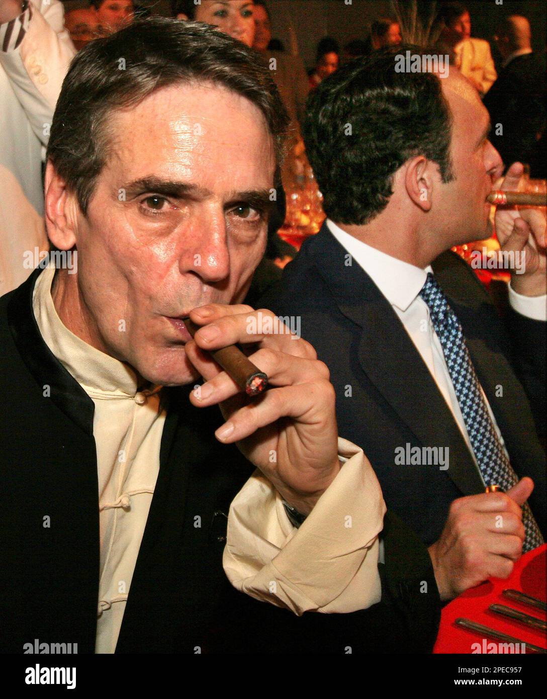 British actor Jeremy Irons, left, smokes a cigar Friday, Feb. 25, 2005 ...