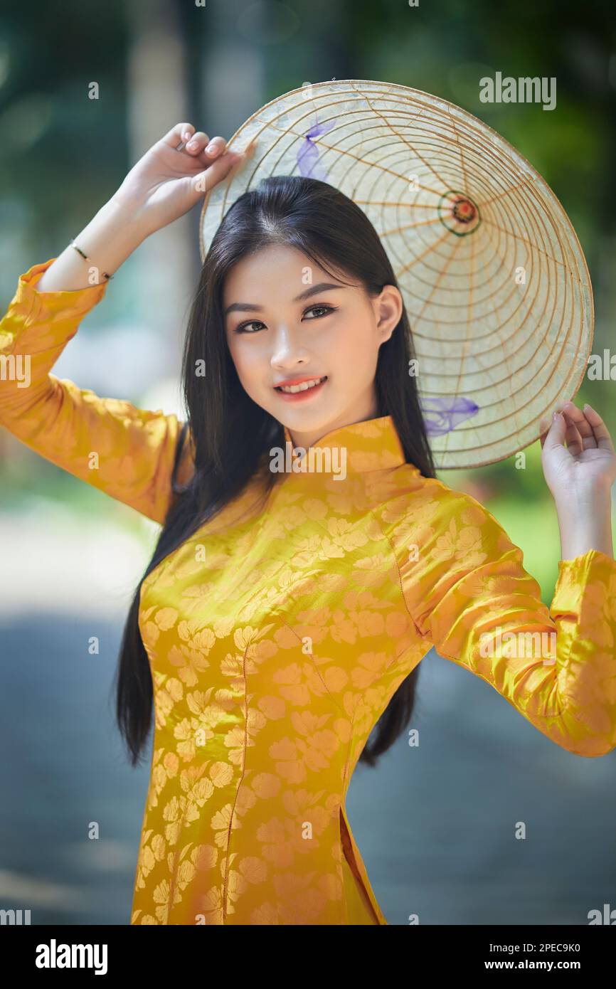 Ho Chi Minh city, Viet Nam: Vietnamese girl going to pagoda in ao dai ...