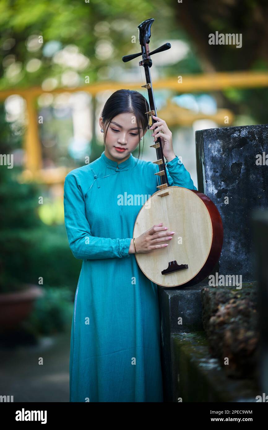 Ho Chi Minh city, Viet Nam: Vietnamese girl going to pagoda in ao dai ...