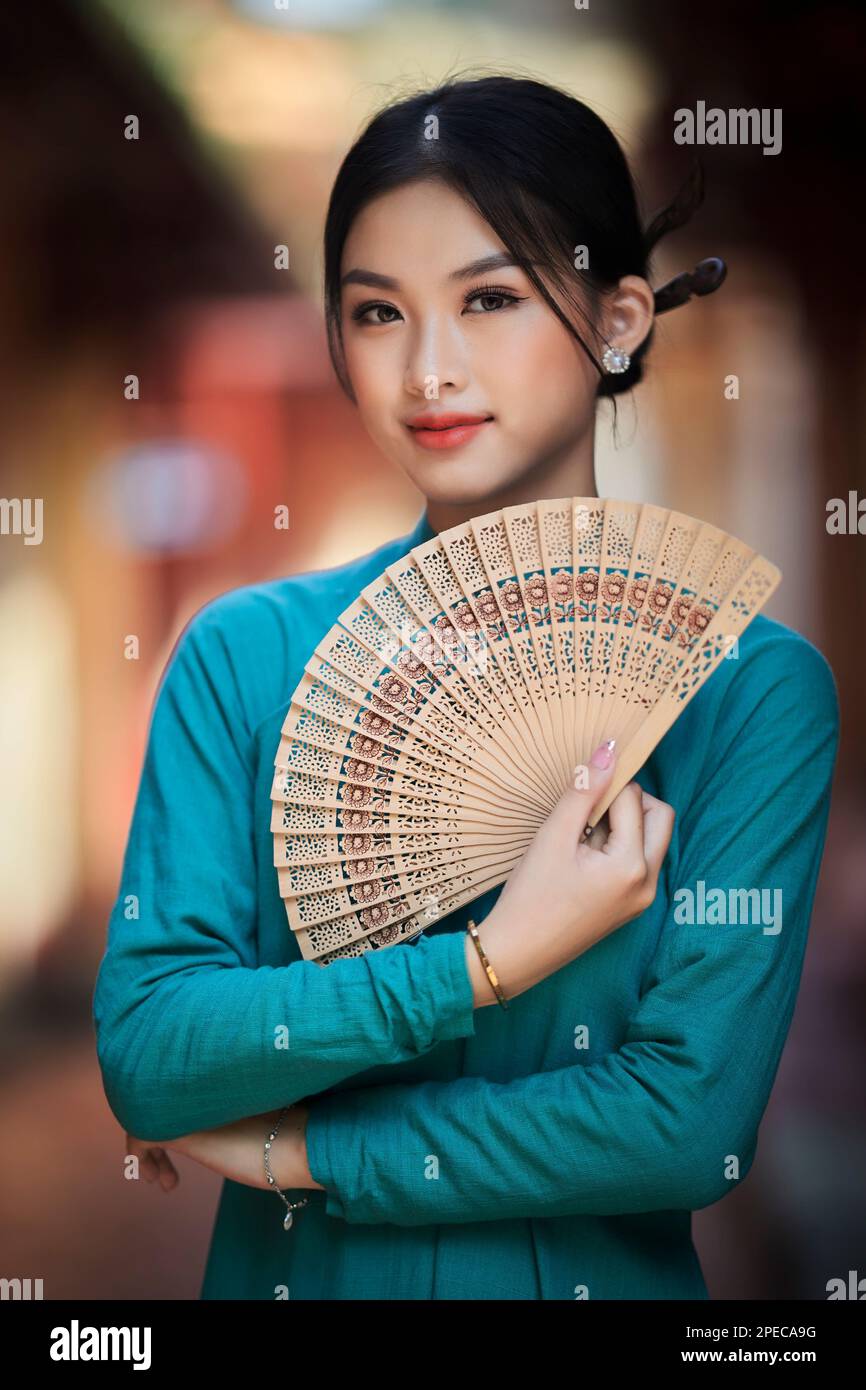 Ho Chi Minh city, Viet Nam: Vietnamese girl going to pagoda in ao dai ...