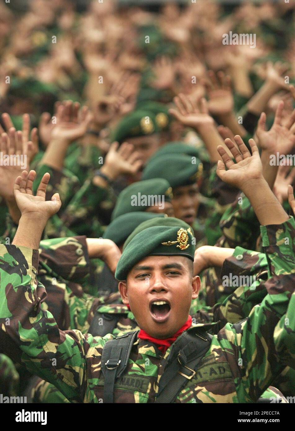 Indonesian soldiers of the Strategic Reserve Command (KOSTRAD) raise ...