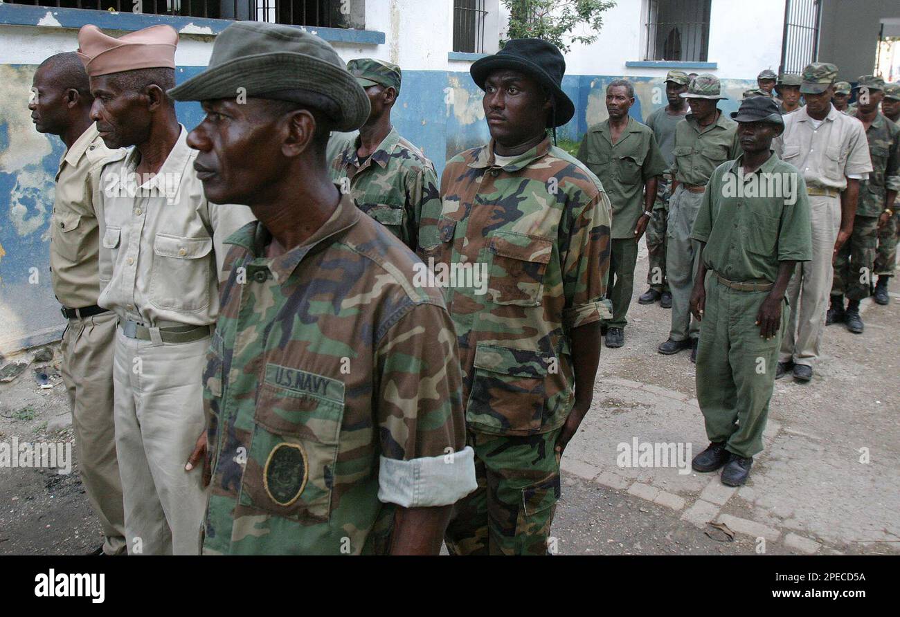 **FILE** A group of former soldiers of the disbanded Haitian Army stand ...