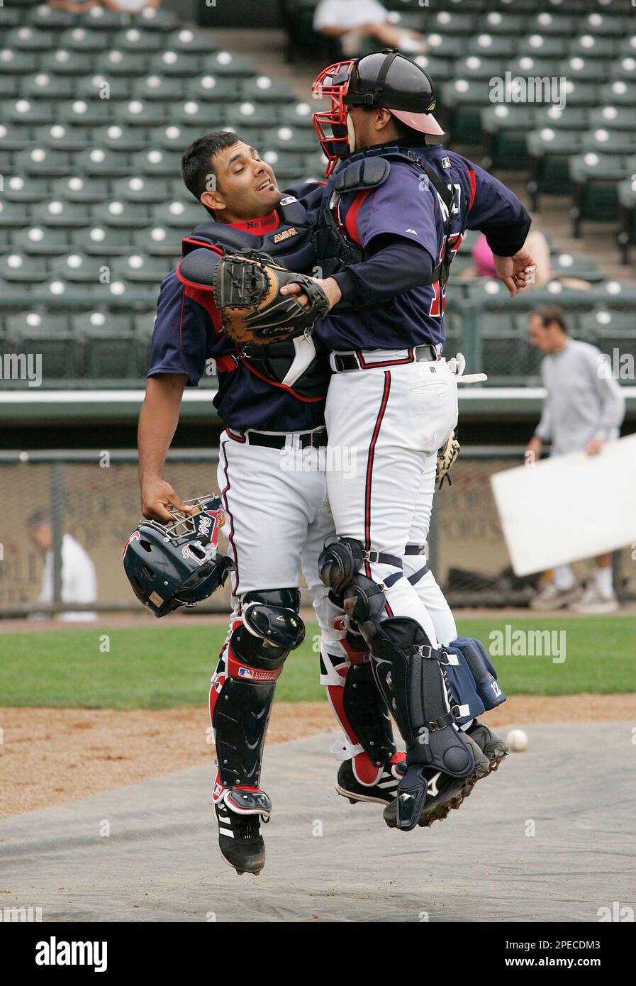 Atlanta Braves catcher Johnny Estrada, right, bumps chests in the air ...