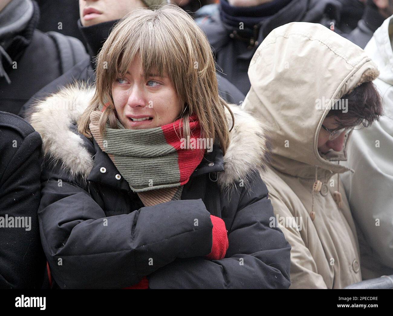 A girl bursts into tears as she attends the funerals of Father Luigi ...