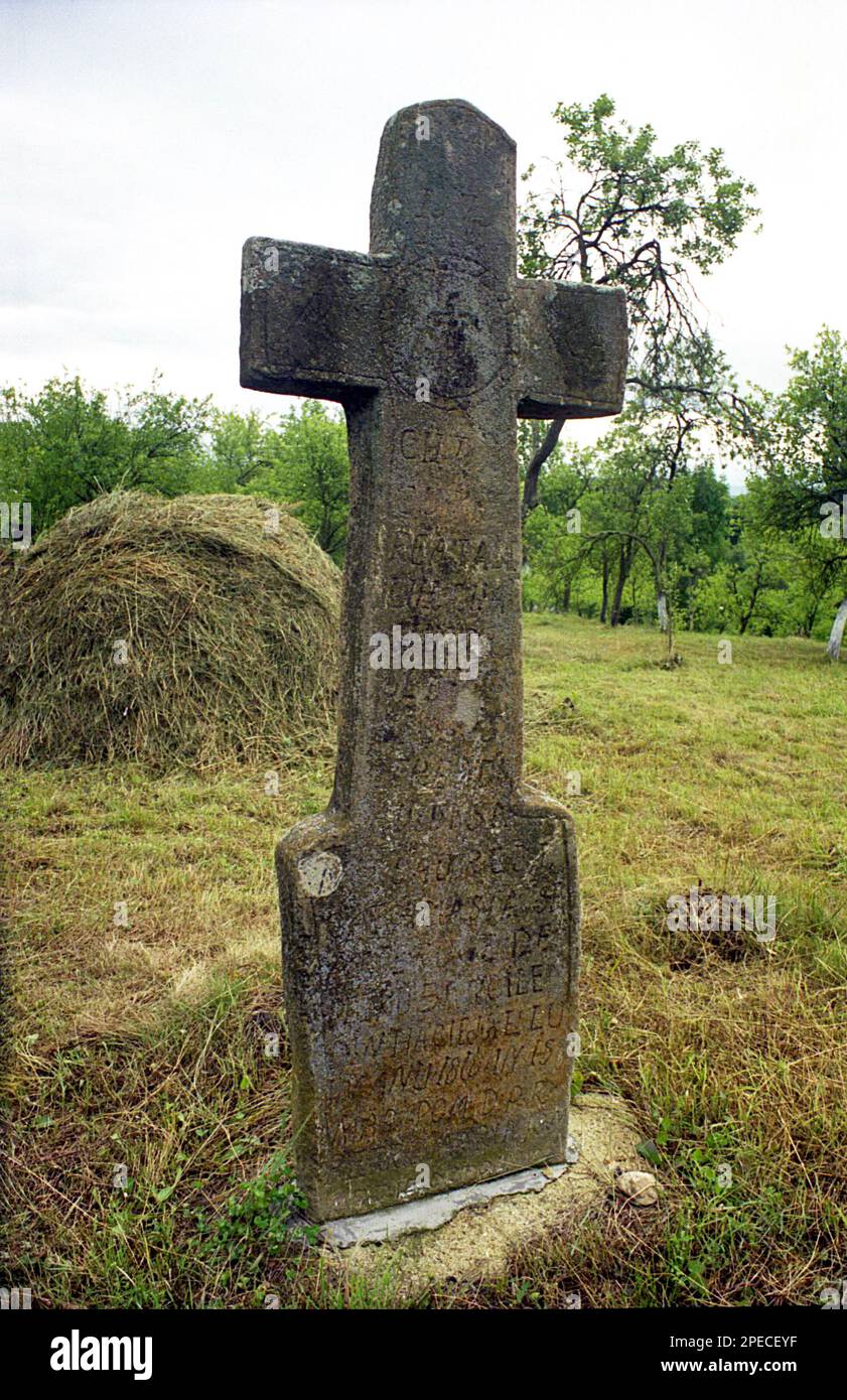 Hunedoara County, Romania, 2002. Stone cross with carved inscriptions ...
