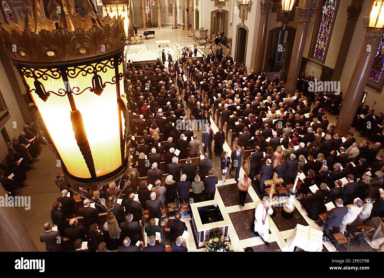 A procession makes its way down the center aisle of the Cathedral of ...