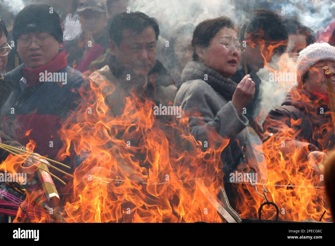Chinese burn incense sticks to mark the Lantern Festival, at the Lama ...