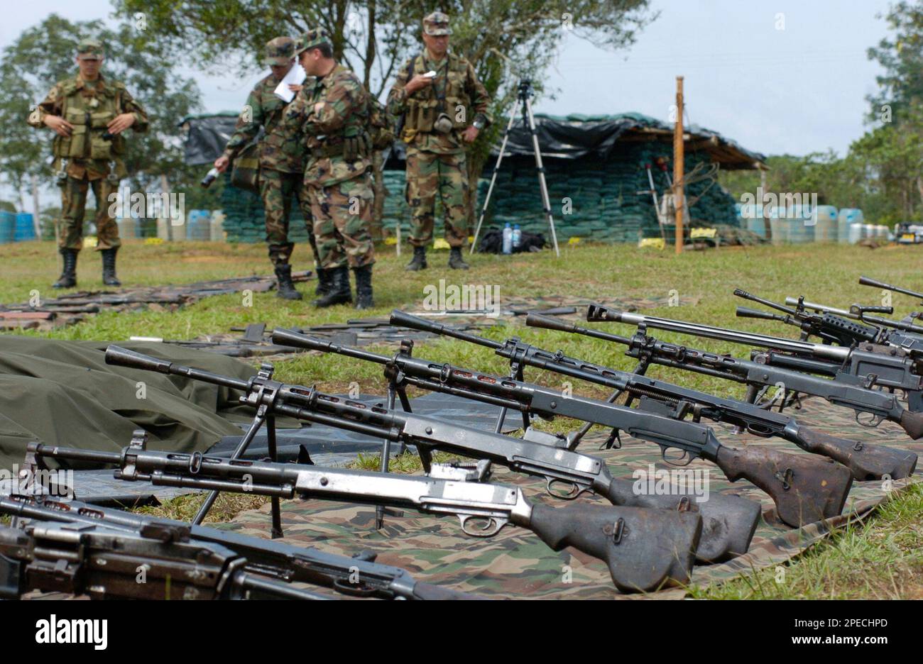 Soldiers watch over weapons seized to rebels of the Revolutionary Armed ...