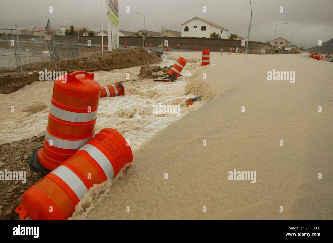 Rushing water undermines the pavement on a street, Monday, Feb. 21 ...
