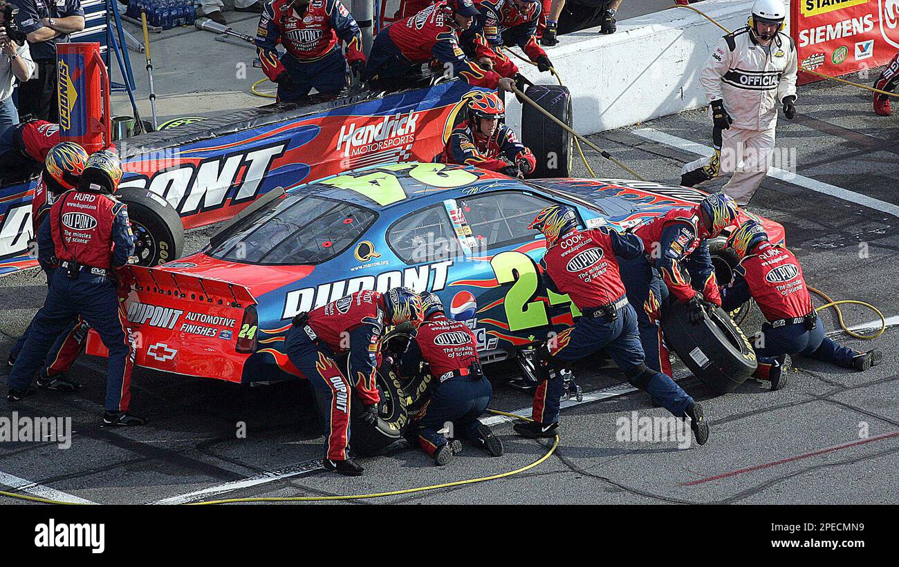 Jeff Gordon's pit crew services his car during a pit stop in the ...