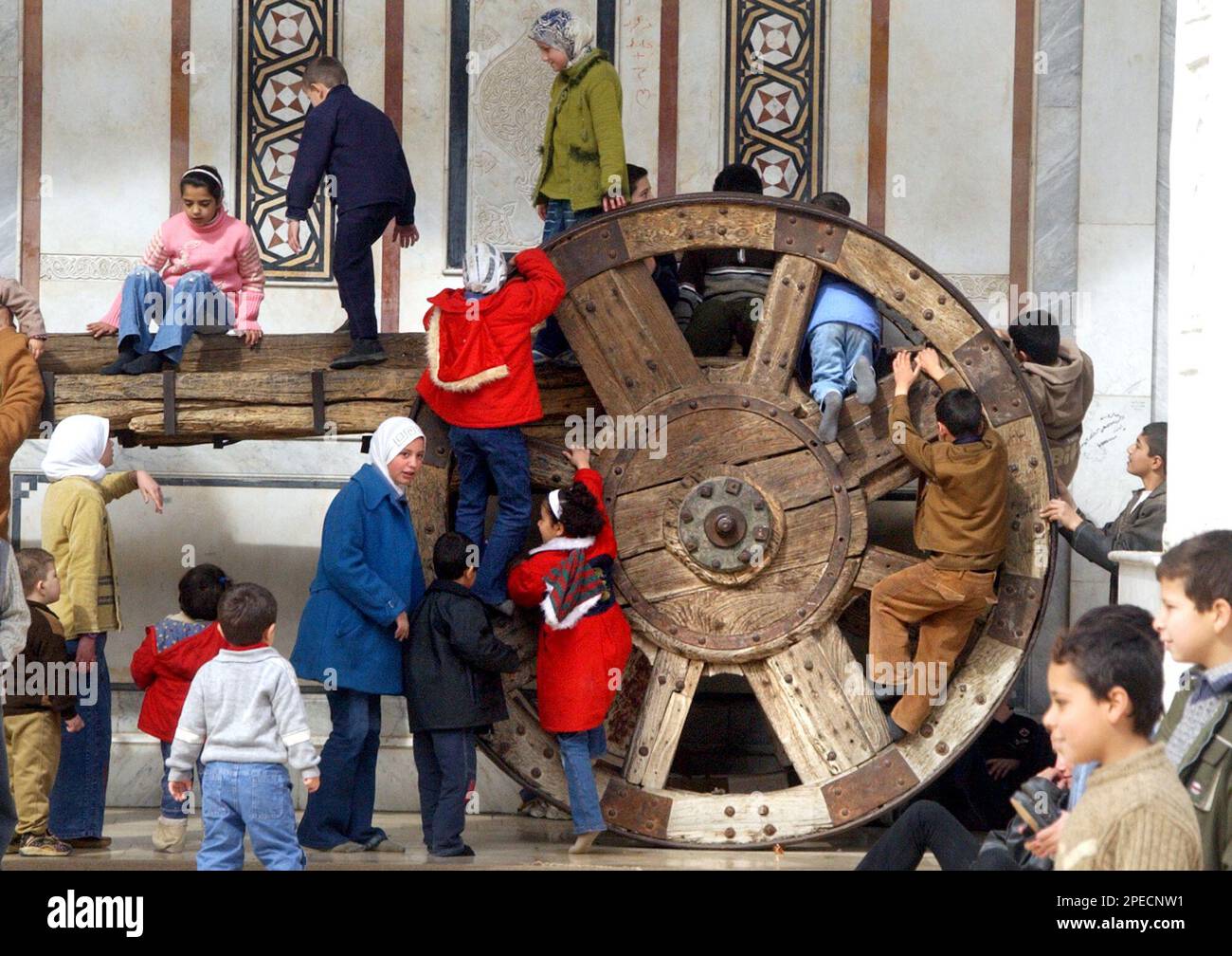 Syrian children play on an ancient canon at the Omayyad Mosque of ...