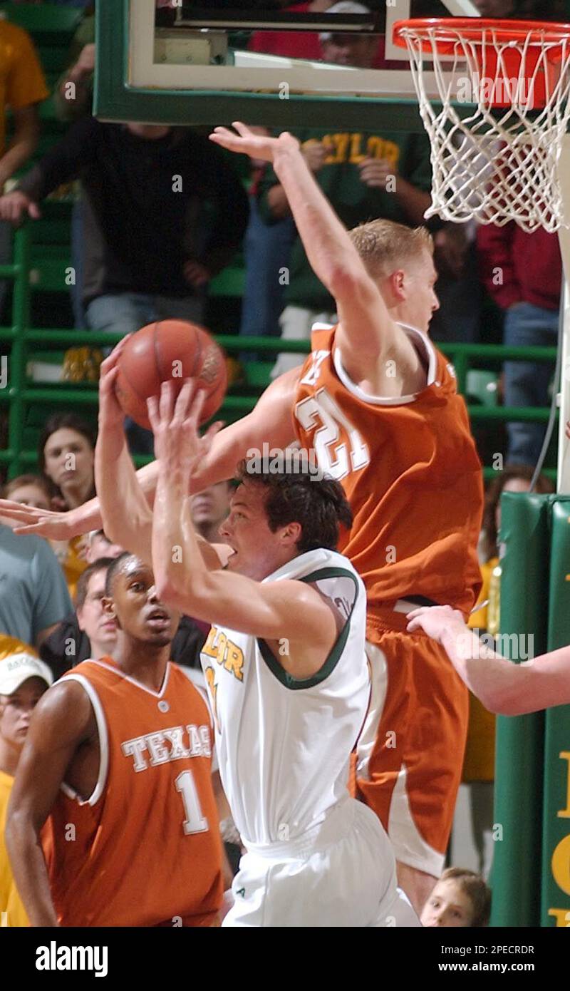 Baylor's Aaron Bruce pulls down a first-half rebound next to Texas ...