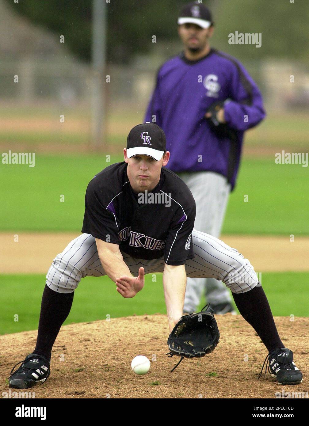 Colorado Rockies' pitcher Tim Drew practices fielding grounders from ...