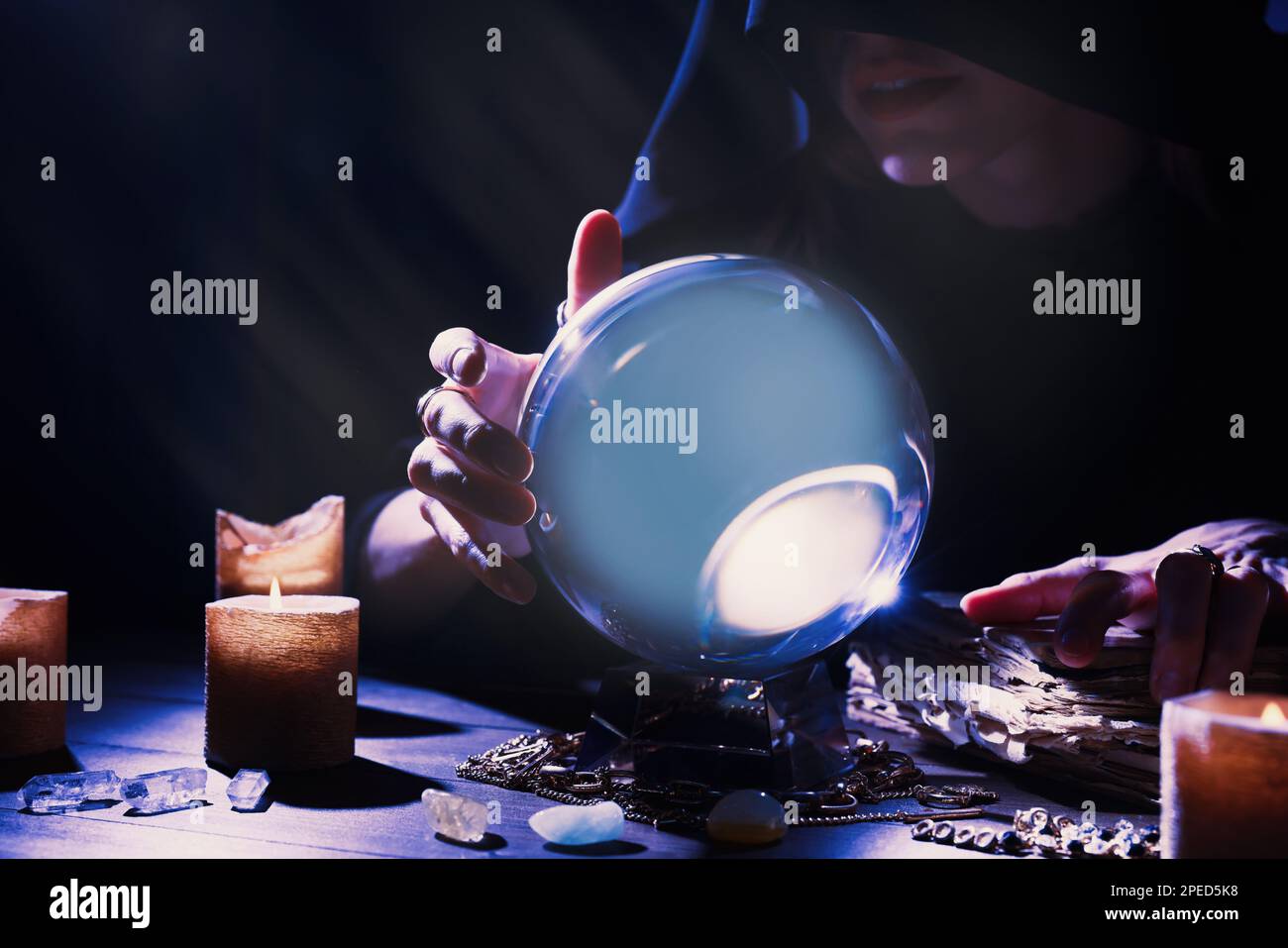 Soothsayer Using Crystal Ball To Predict Future At Table In Darkness