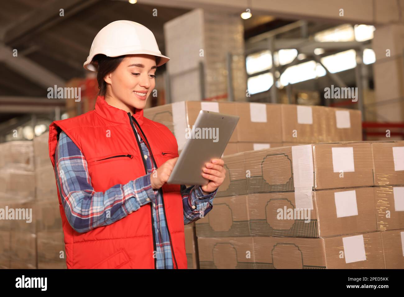 Woman with tablet working at warehouse. Logistics center Stock Photo ...