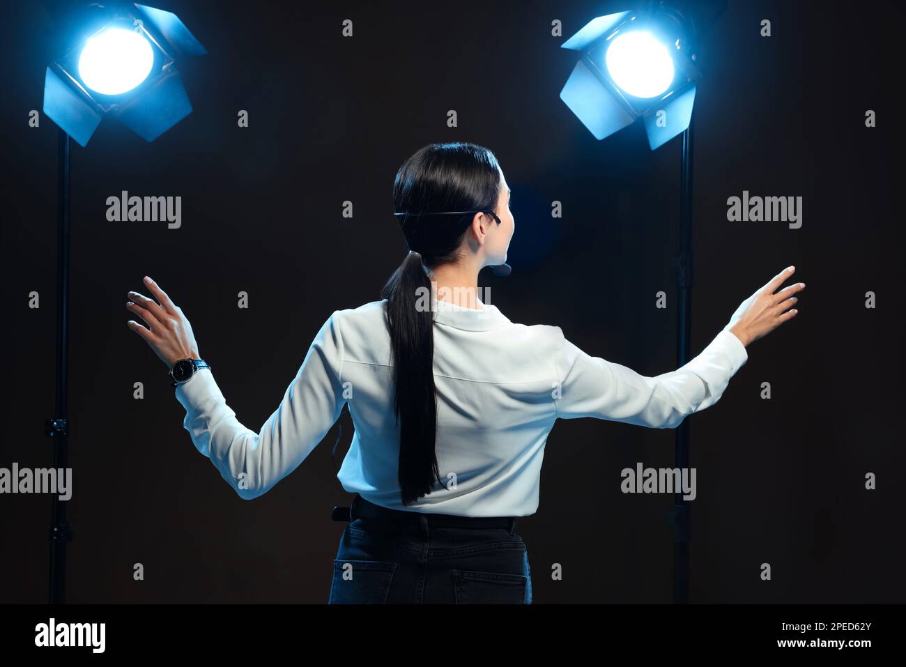 Motivational speaker with headset performing on stage, back view Stock ...
