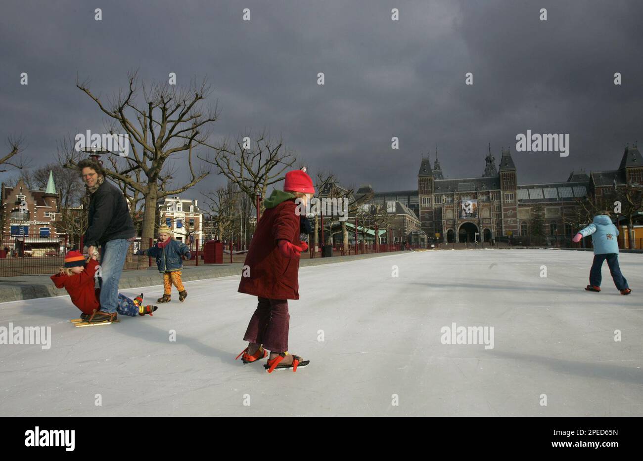 Dutch people enjoy skating at a rink on Museum Square in Amsterdam ...