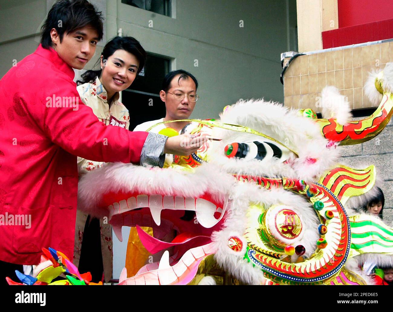 Hong Kong singer Leo Koo poses with a dargon head before a dargon dance ...