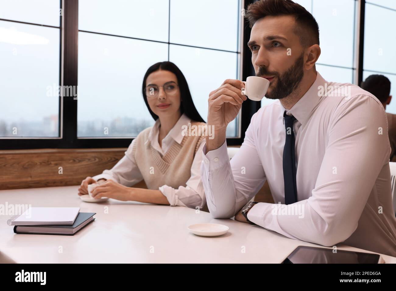 Coworkers talking in cafe during coffee break Stock Photo - Alamy
