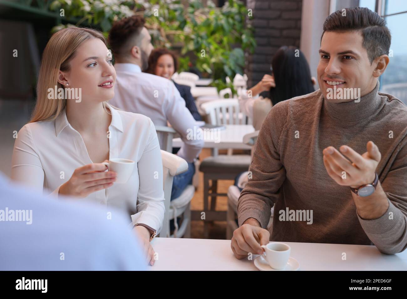 Group of coworkers having coffee break in cafe Stock Photo - Alamy