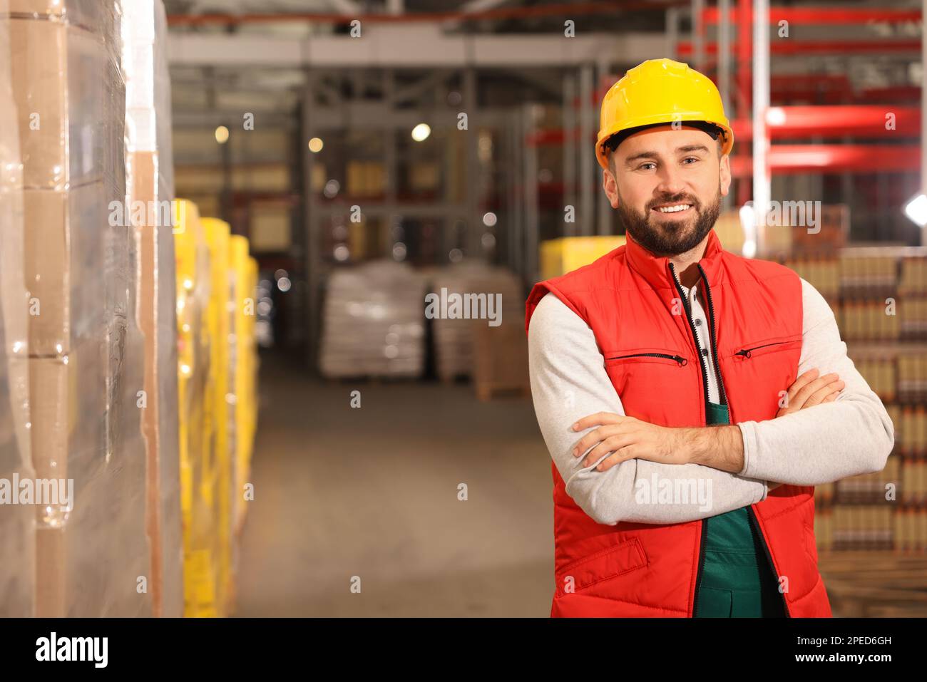 Worker in hardhat and uniform at warehouse. Logistics center Stock ...