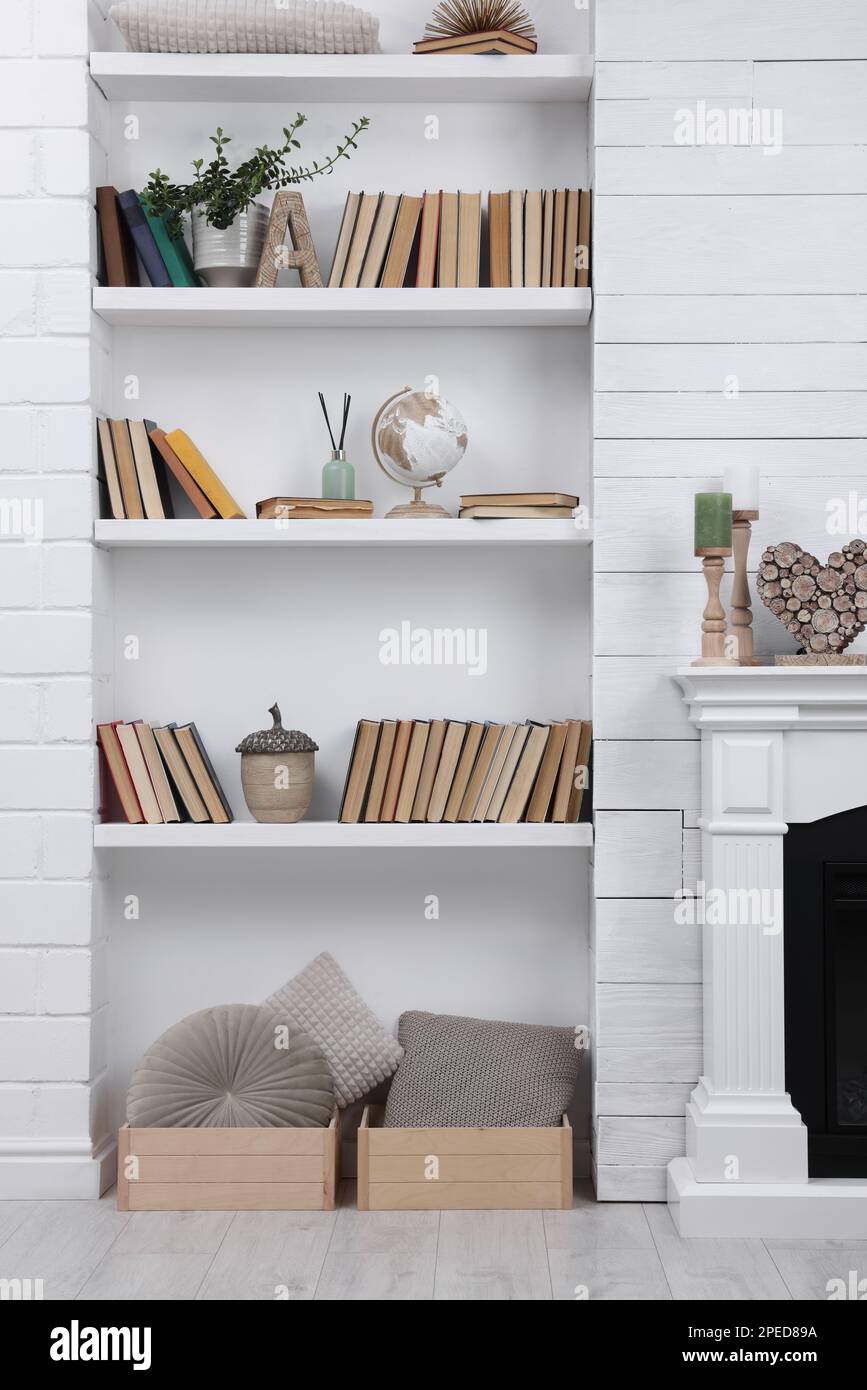 Collection of books and decor elements on shelves indoors. Interior ...