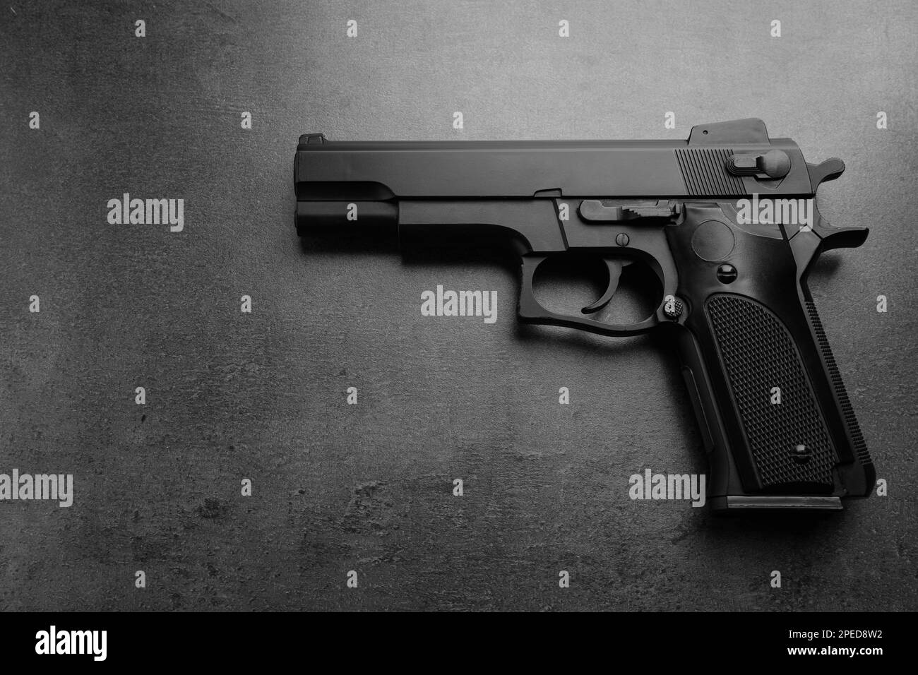 Black metal gun on stone table, top view Stock Photo - Alamy