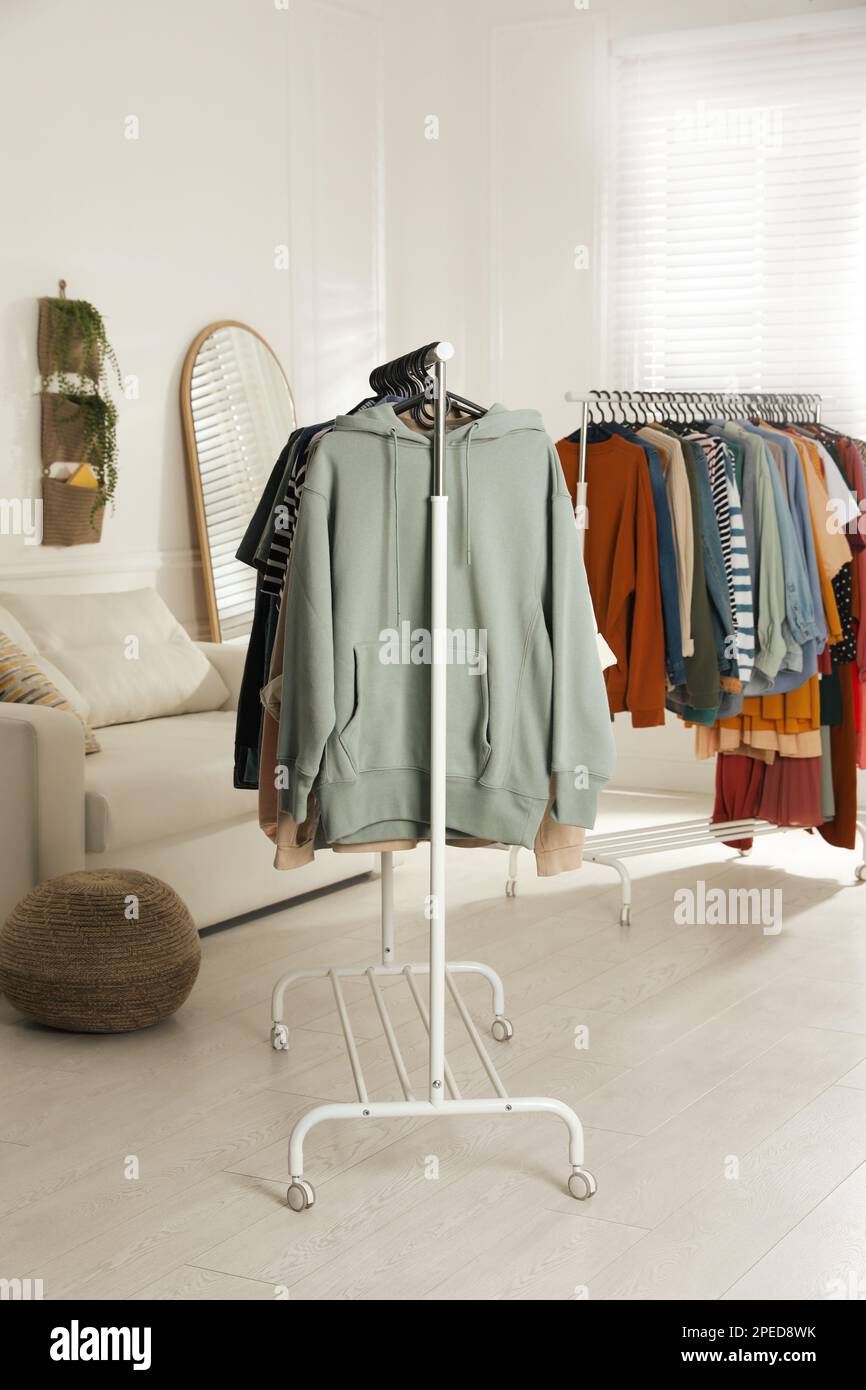 Racks with stylish clothes indoors. Fast fashion Stock Photo - Alamy