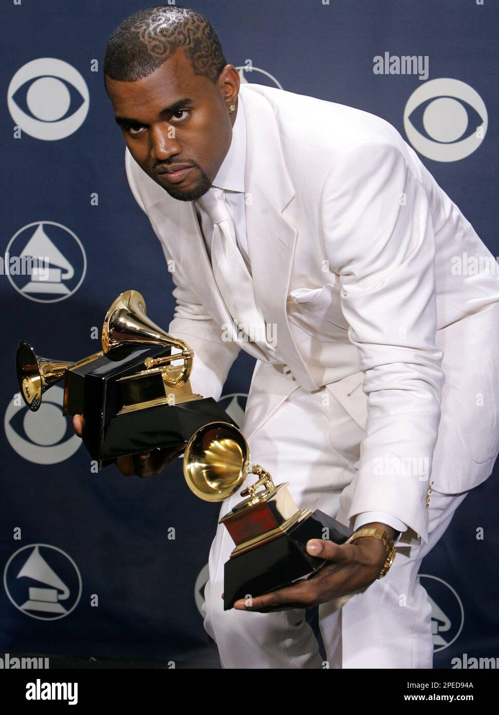 Kanye West poses with his three awards at the 47th Annual Grammy Awards ...