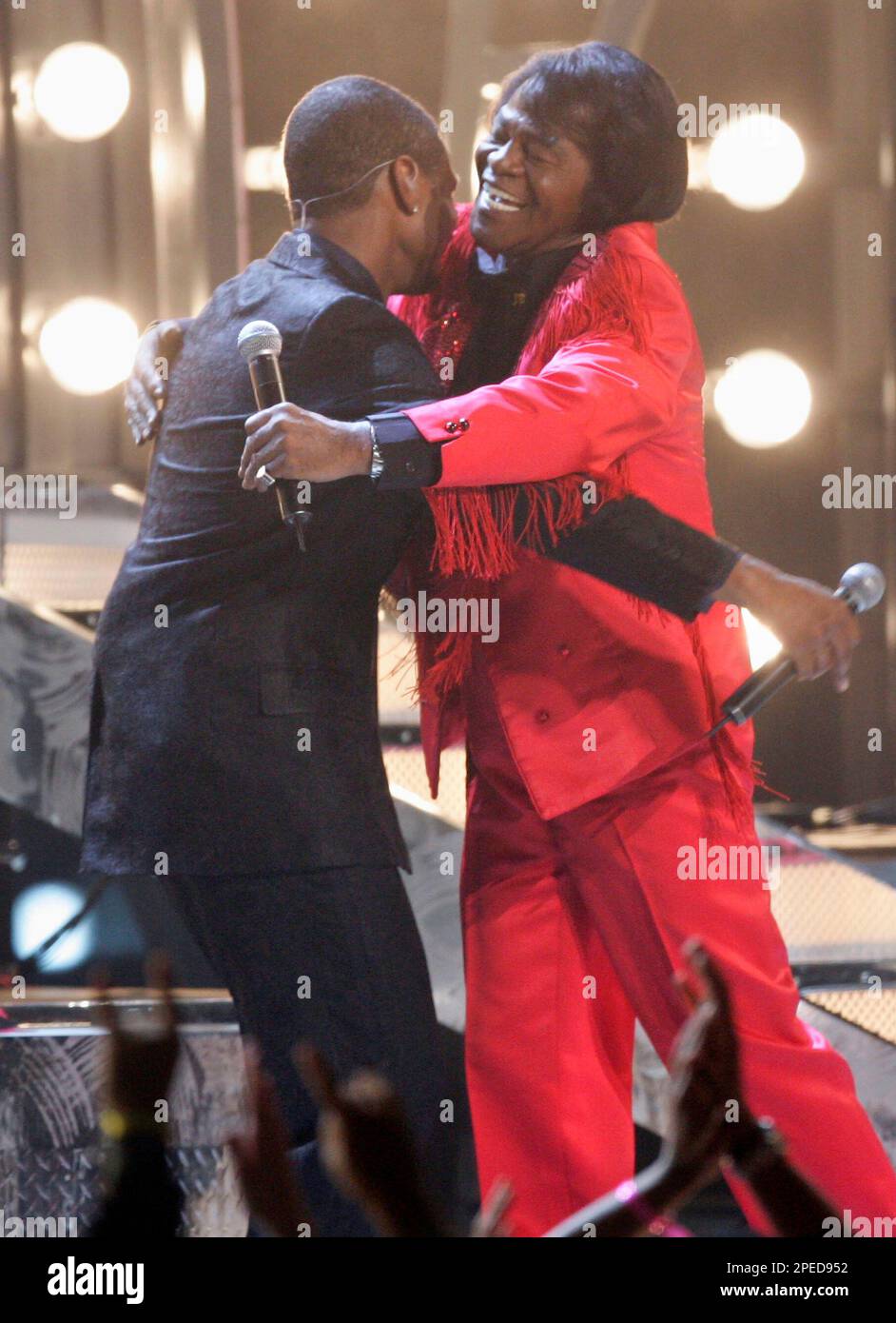 Usher and James Brown hug after performing "Caught Up" at the 47th ...
