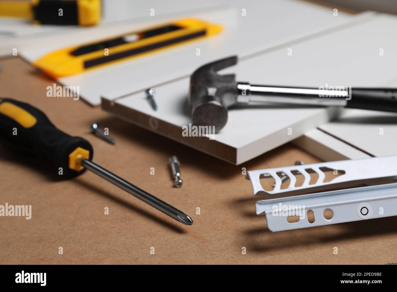 Furniture parts and equipment for self-assembly on brown background ...