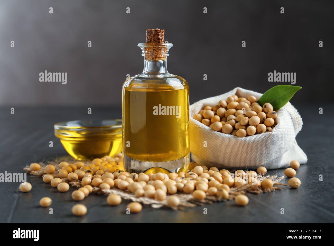 Composition with soybean oil on grey table Stock Photo - Alamy