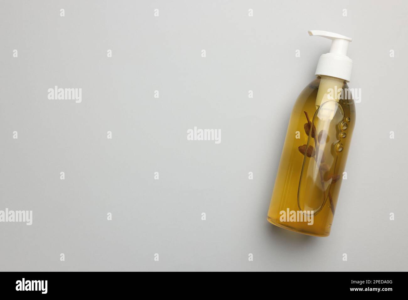 Bottle of liquid soap on light grey background, top view. Space for ...