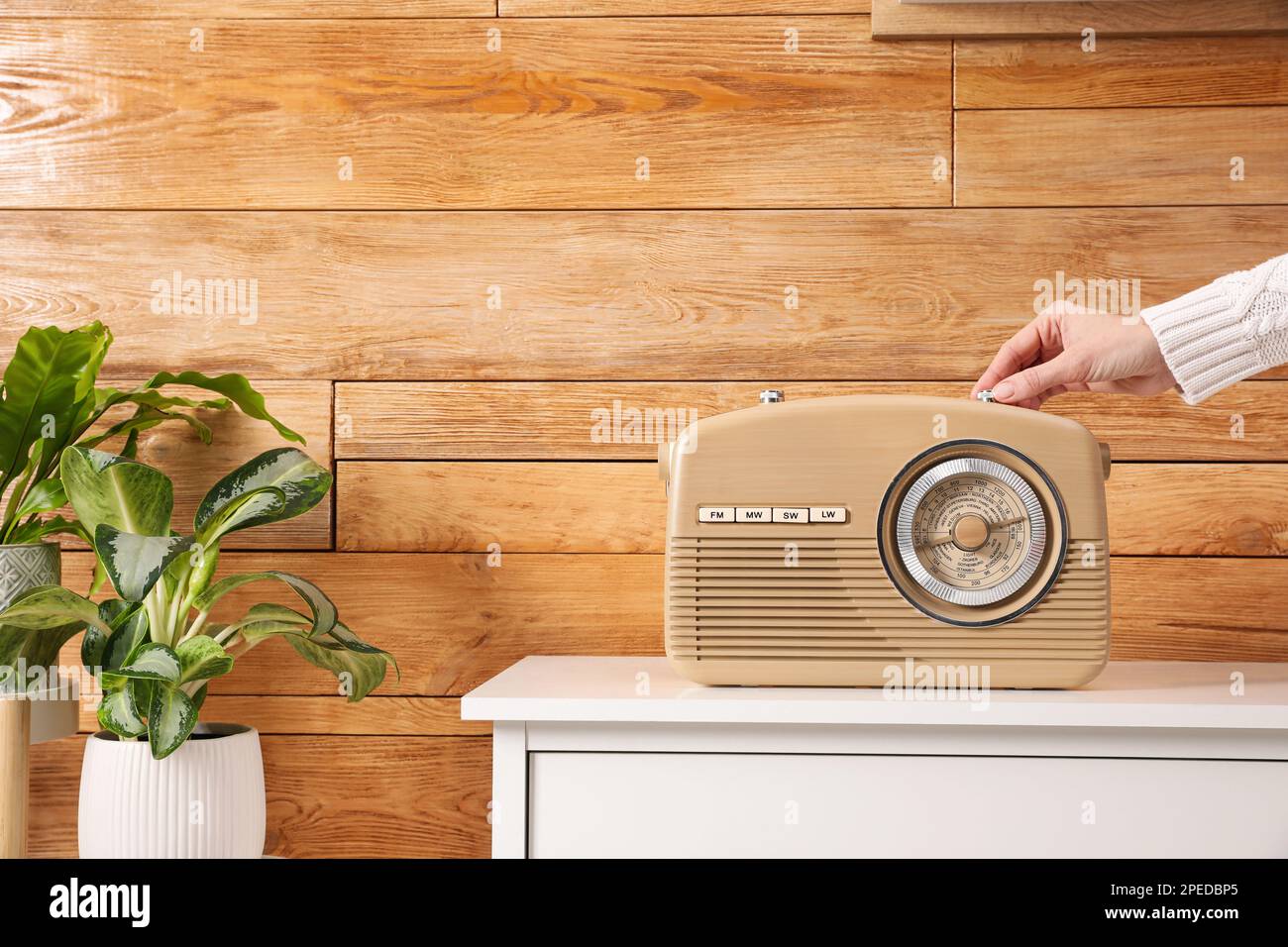 Woman turning on radio hi-res stock photography and images - Alamy
