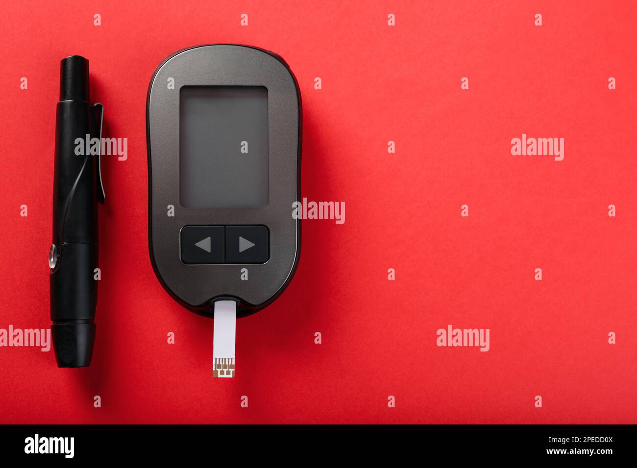 Digital glucometer, test strip and lancet pen on red background, flat ...