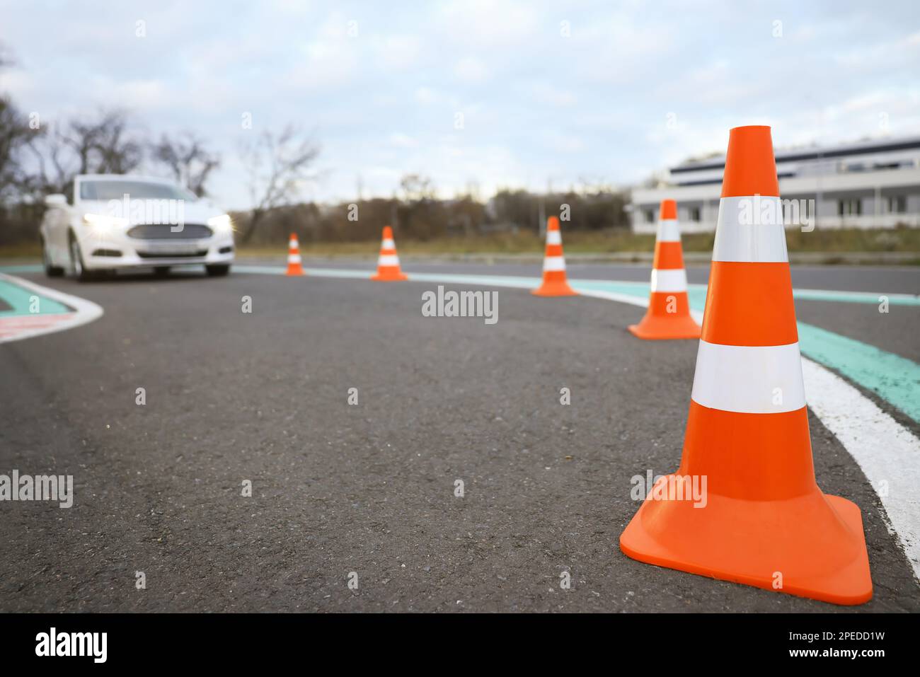 Modern car at test track, focus on traffic cone. Driving school Stock ...