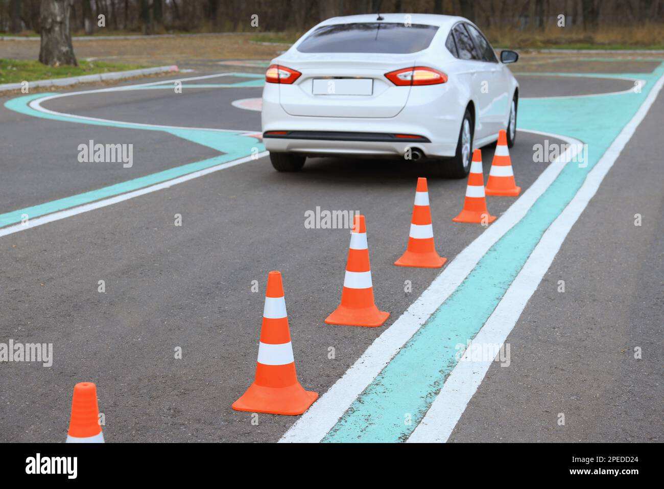 Modern car on driving school test track with traffic cones Stock Photo ...