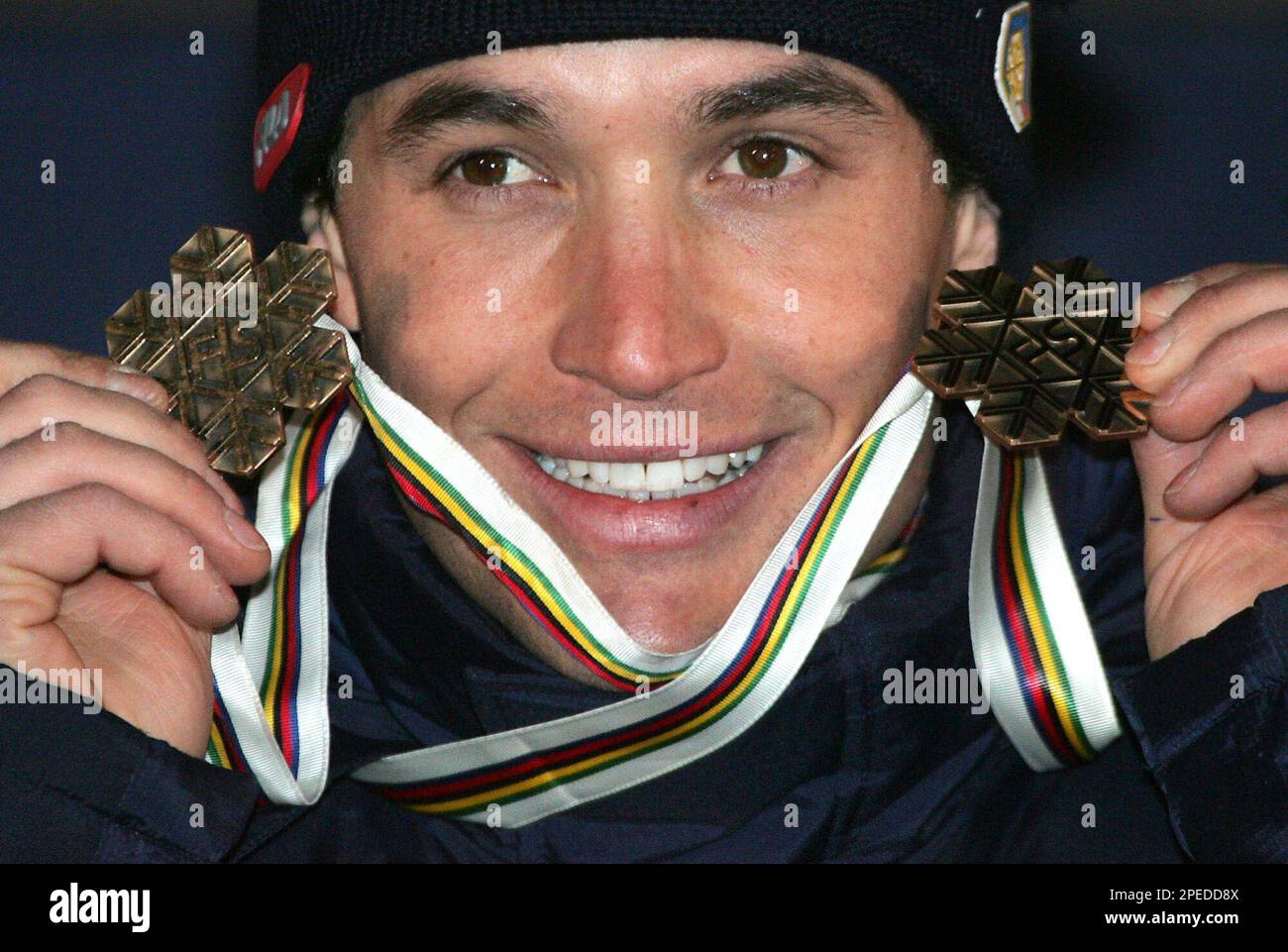 Italy's bronze medallist Giorgio Rocca displays his two bronze medals ...